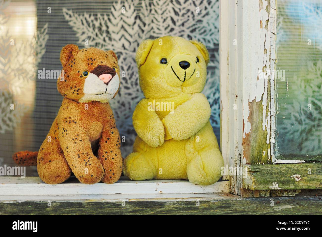 Two soft toys on the window sill Stock Photo - Alamy