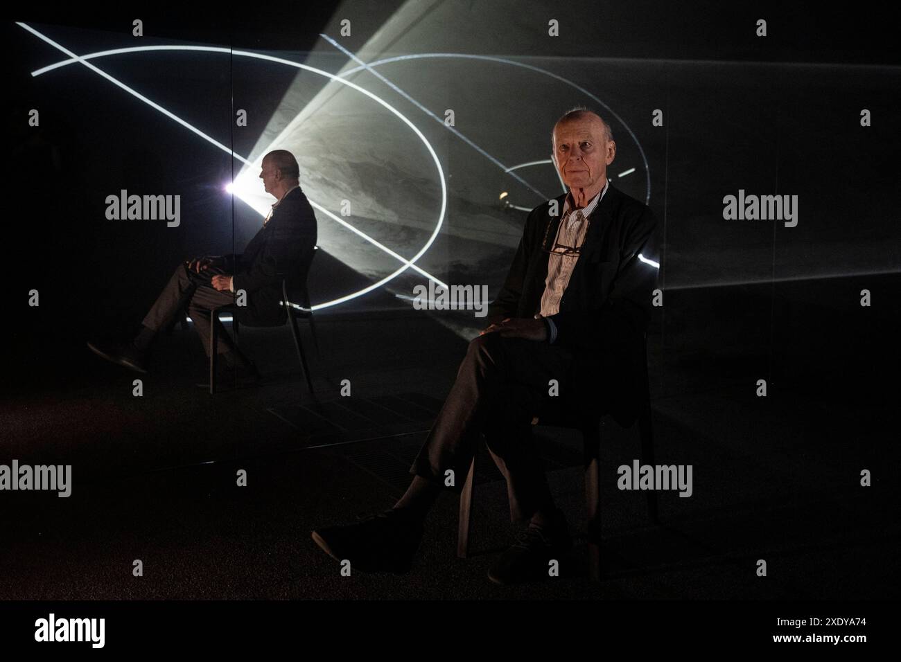 London, UK. 25 June 2024. Artist Anthony McCall in one of his immersive ...