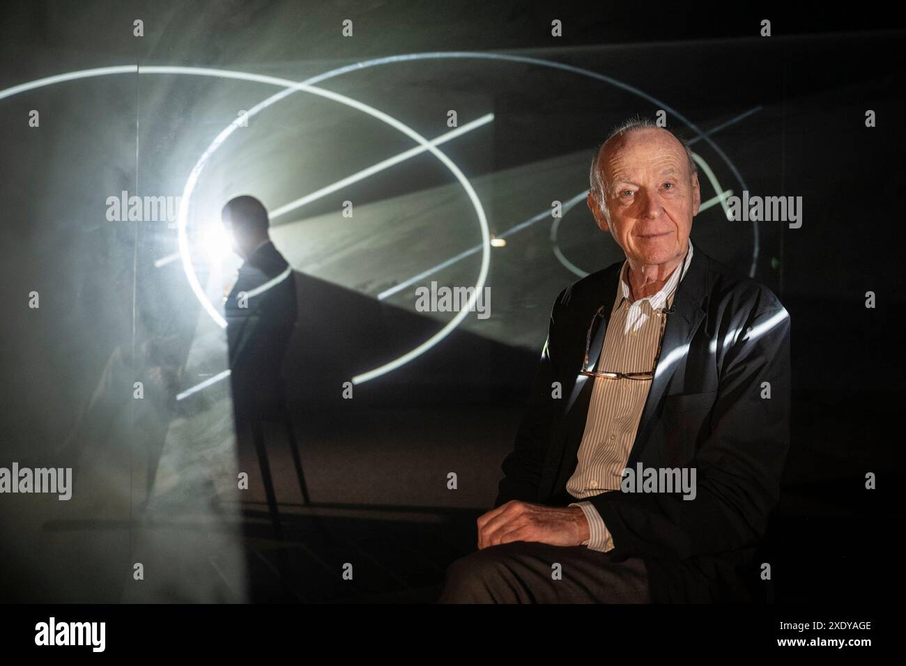 London, UK. 25 June 2024. Artist Anthony McCall in one of his immersive ...