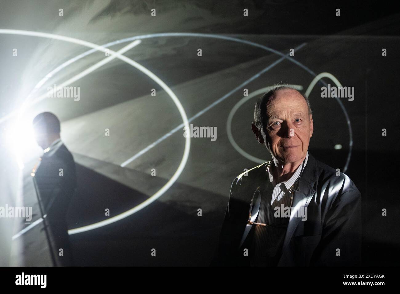 London, UK. 25 June 2024. Artist Anthony McCall in one of his immersive ...