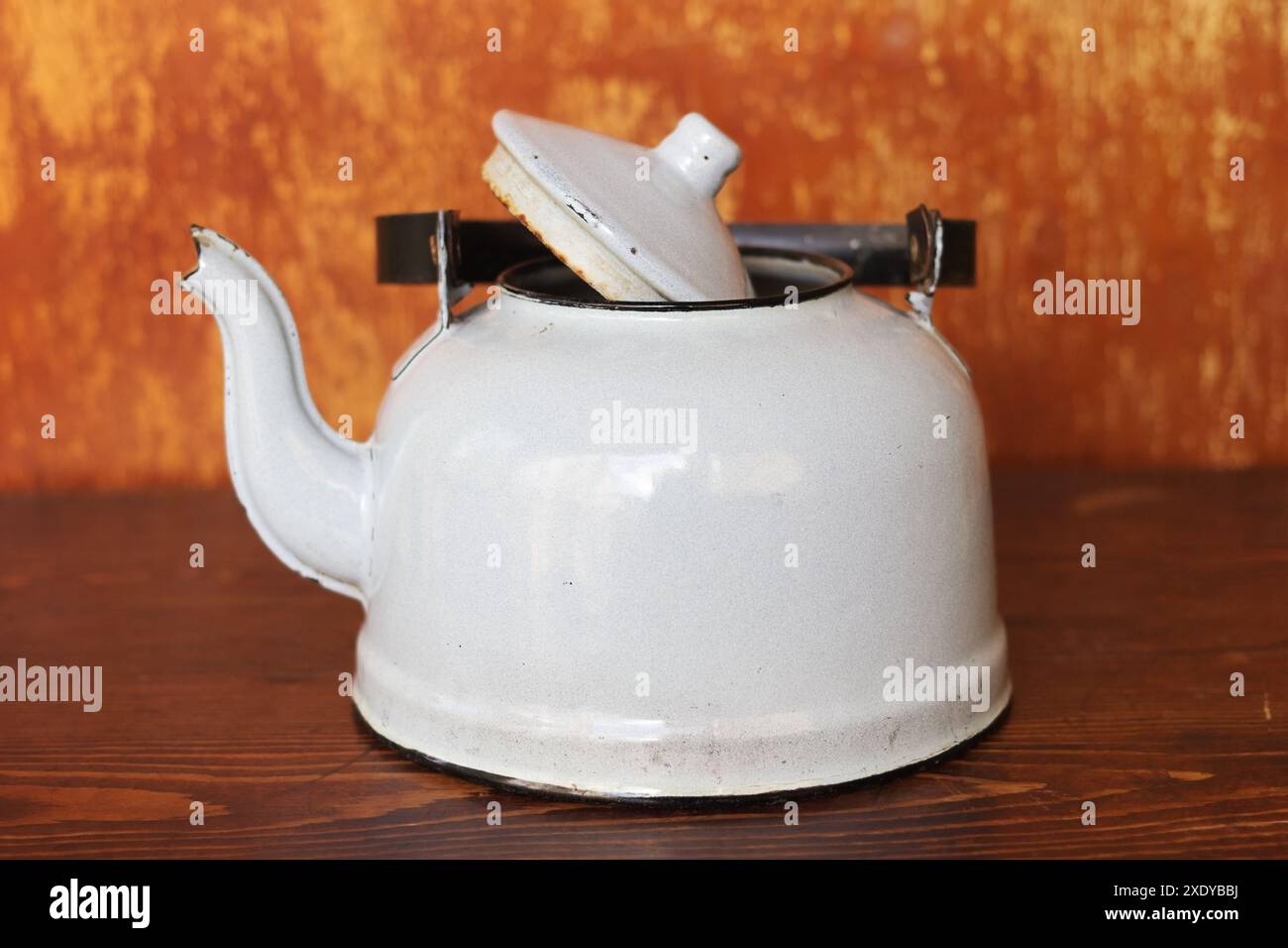 Old enamel kettle with lid slightly ajar Stock Photo - Alamy