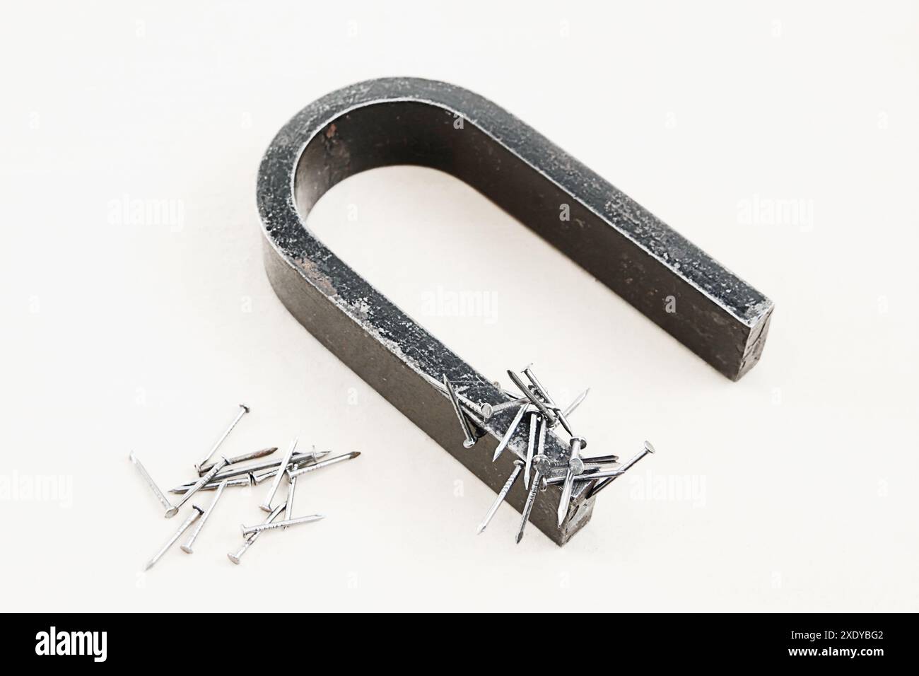 Magnet and metal nails Stock Photo - Alamy