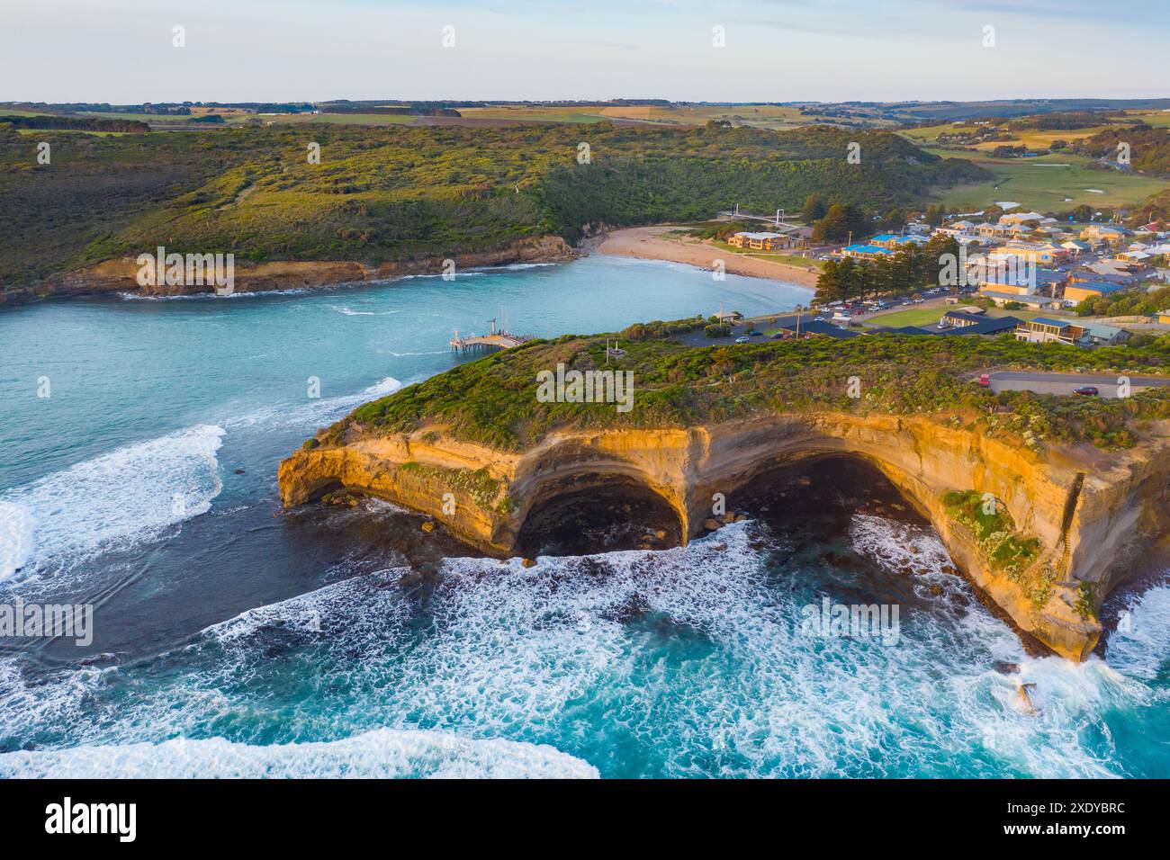 Aerial view of waves breaking into rocky caves eroded into coastal ...