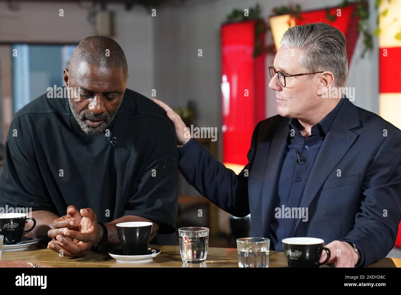 Labour leader Sir Keir Starmer, rests his hand on the shoulder of Idris ...