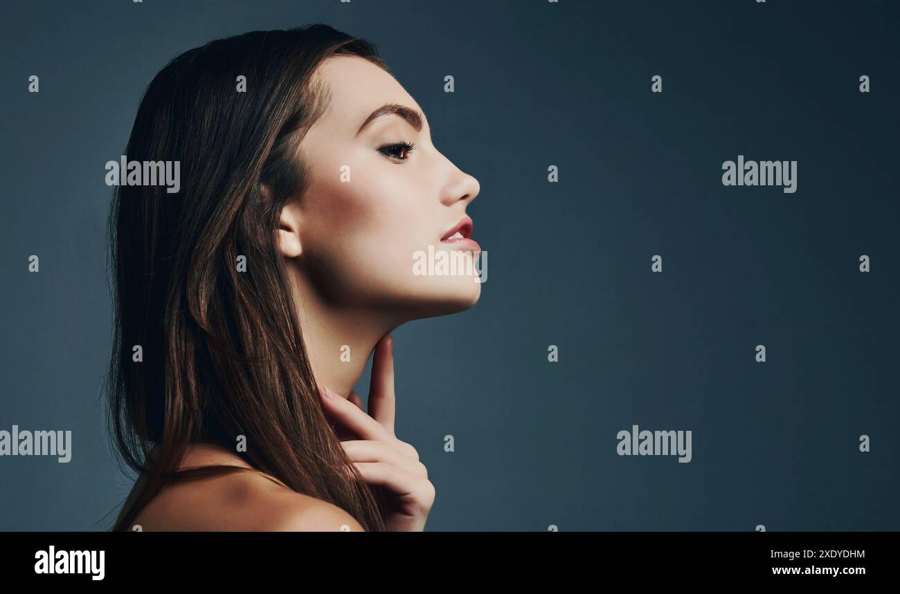 Beauty, face and profile with natural woman in studio isolated on blue ...