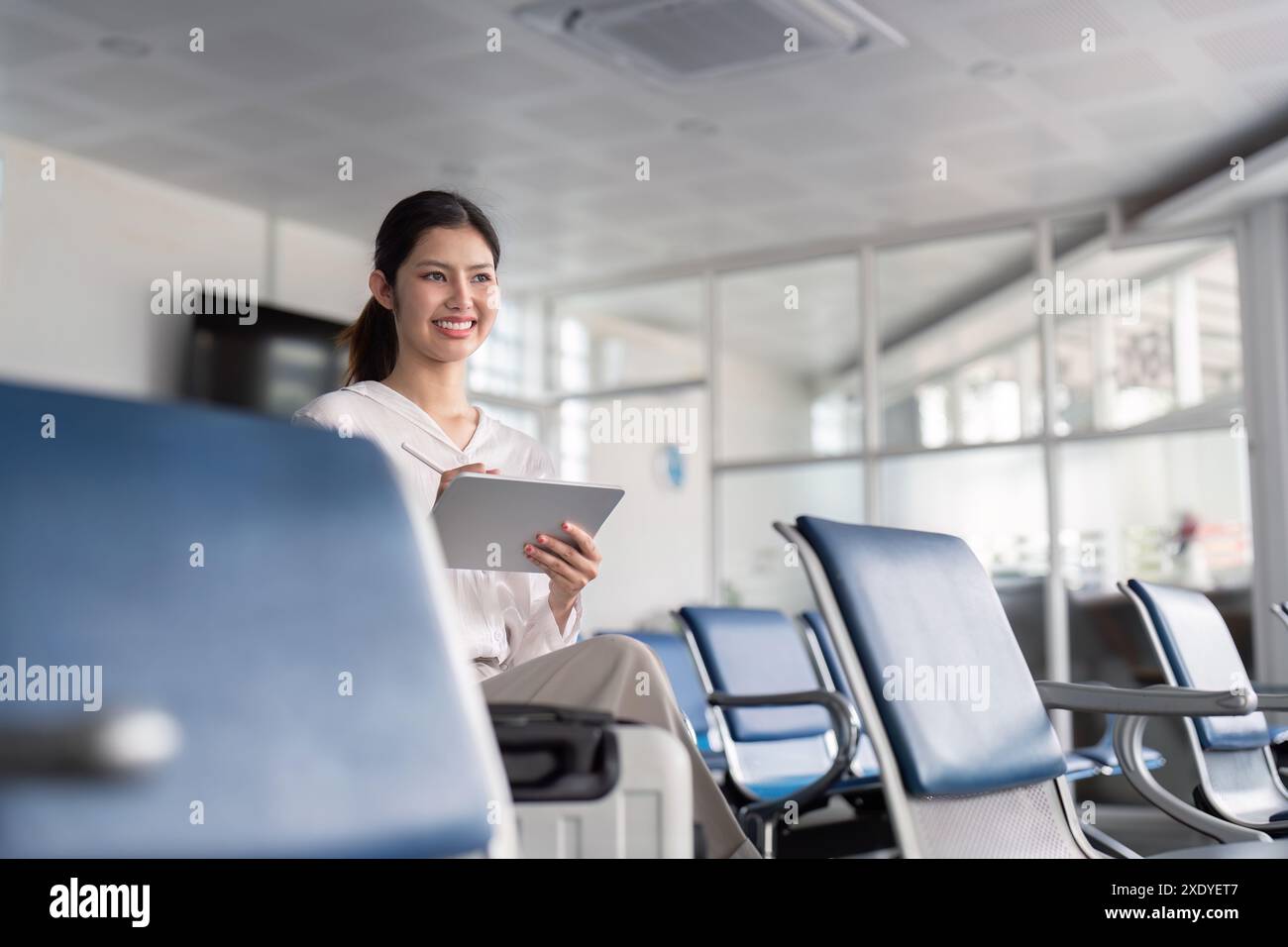 Businesswoman Professional Using Tablet in Modern Airport Lounge with ... Businesswoman Professional Using Tablet in Modern Airport Lounge with ...