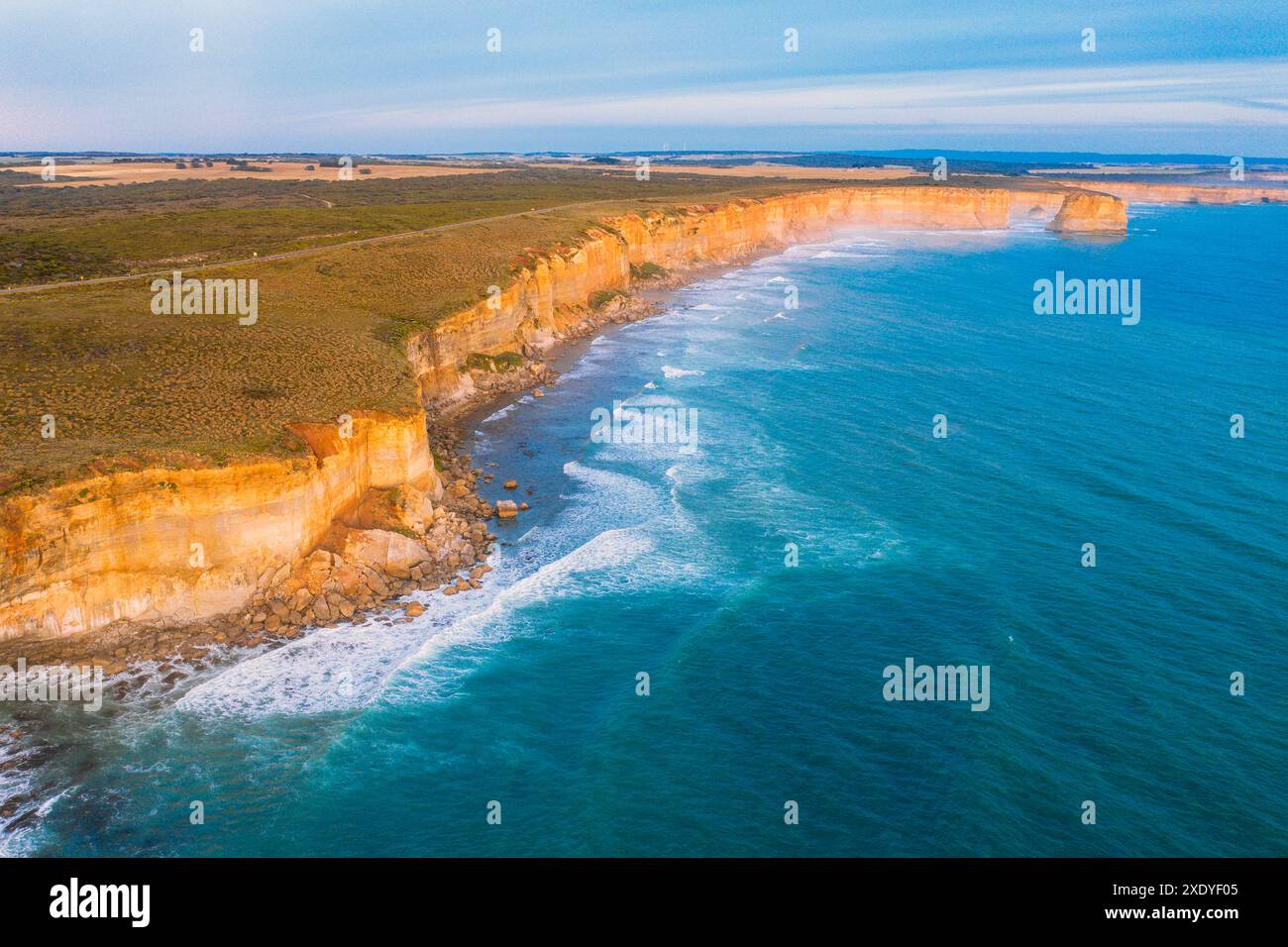Aerial view of sheer sea cliffs along a rugged coastline with vivid ...