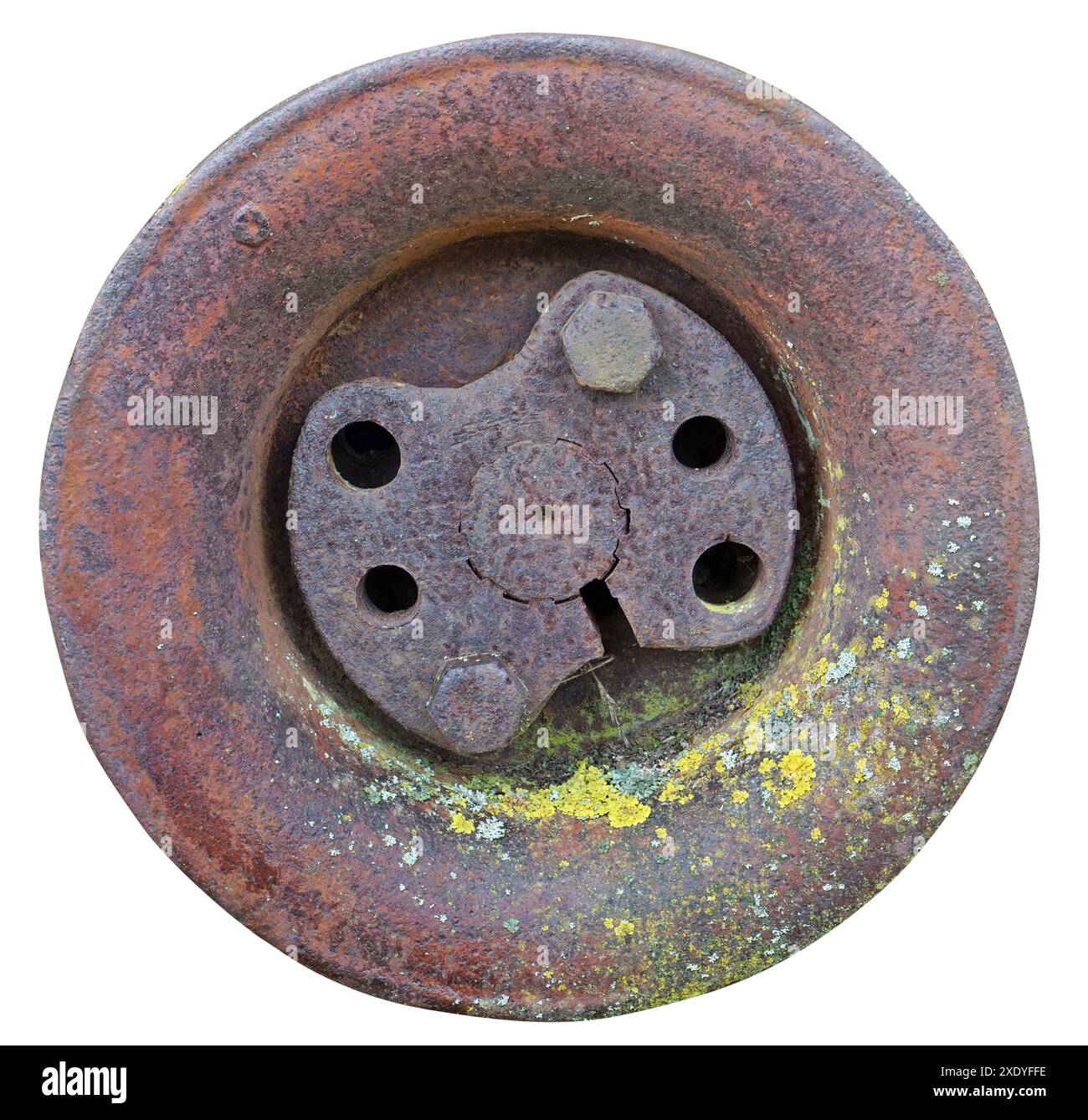 Rusty solid iron wheel from an retro tractor with yellow lichen spots ...