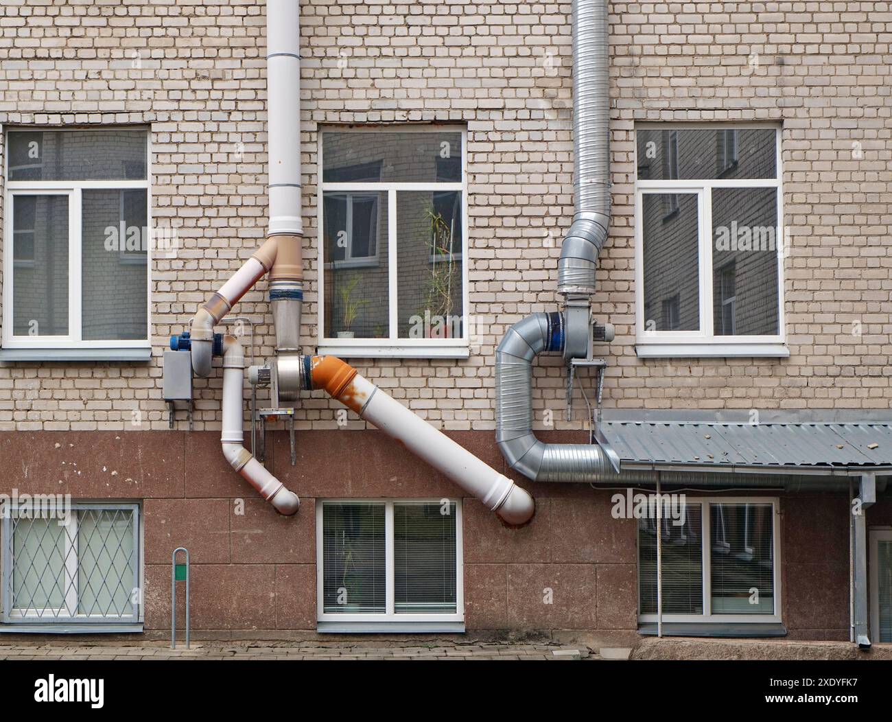 Thick, powerful ventilation pipes air conditioners mounted on the old ...