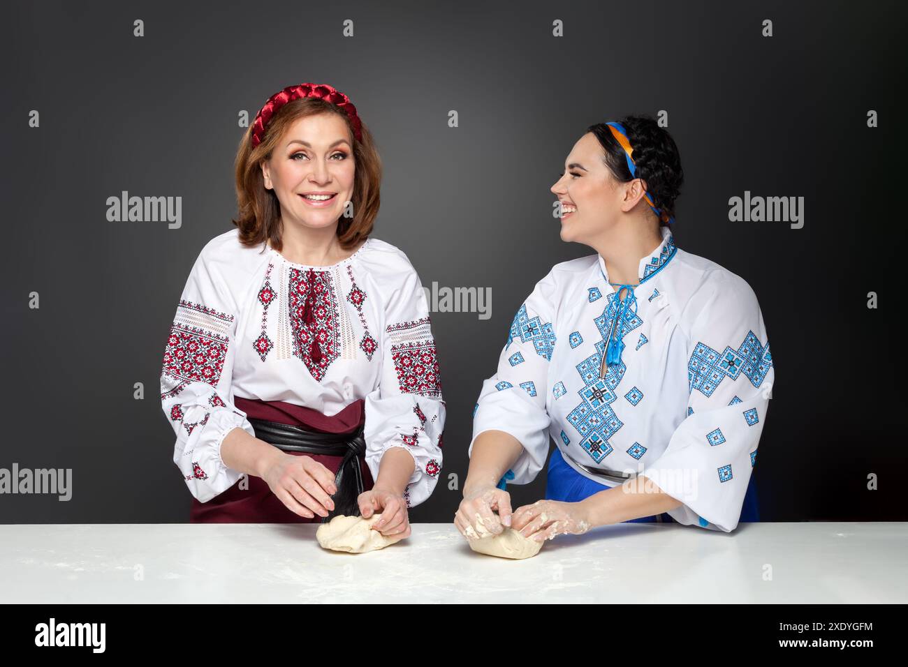 Two Adult woman in traditional ukrainian style. Cooking ukrainian ...