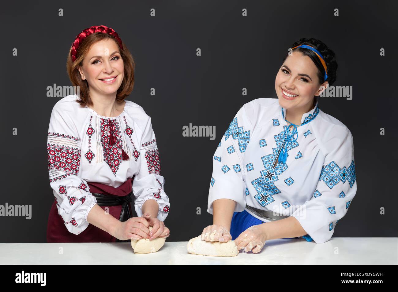 Two Adult woman in traditional ukrainian style. Cooking ukrainian ...