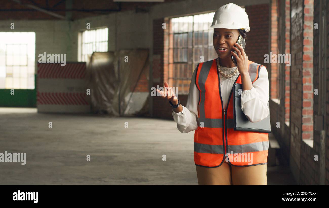 Female Engineer Inspecting Construction Site and Making Phone Call Stock Photo - Alamy