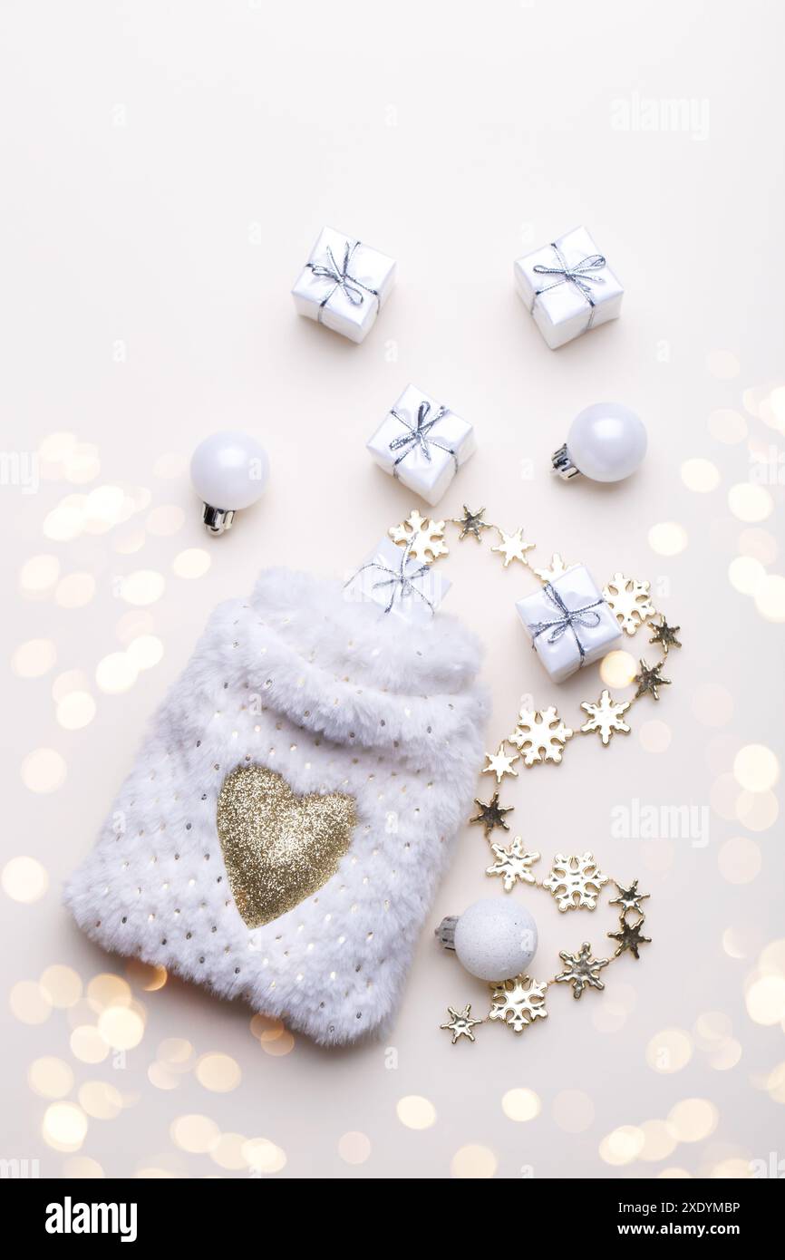 White fluffy sack with small gift boxes on beige background Stock Photo ...