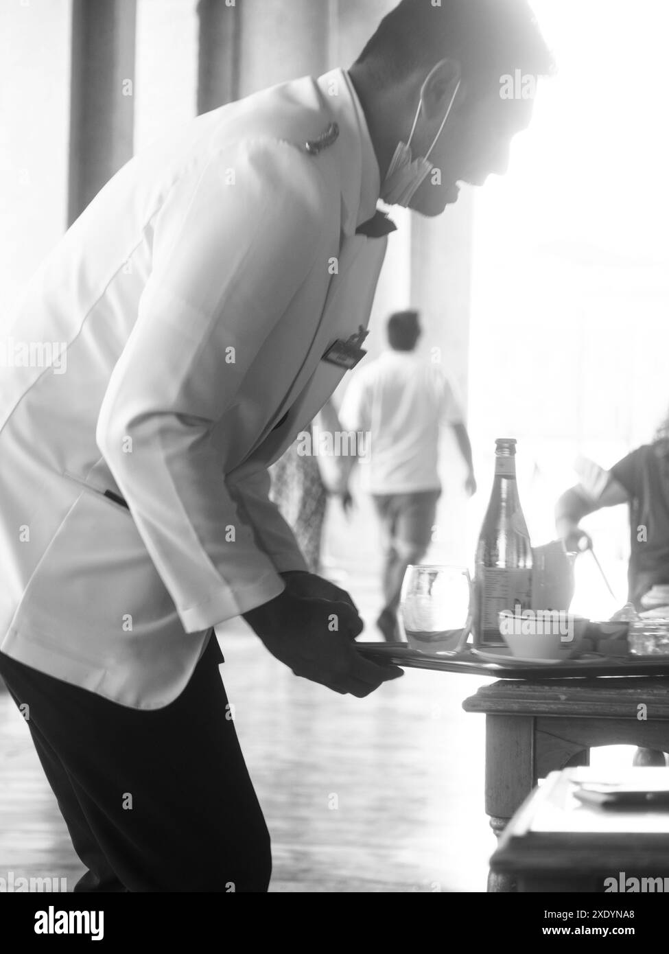 Venice, Italy - June 30th 20220 Waiter wearing a face mask and black ...