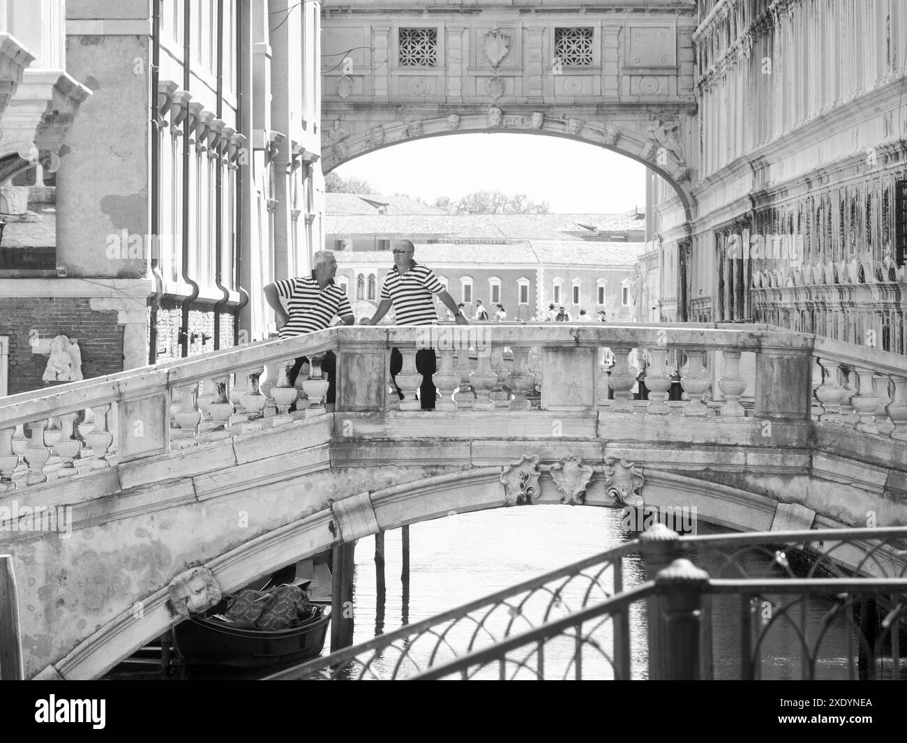 Venice, Italy - June 30th 20220 Two gondoliers taking a break from work ...