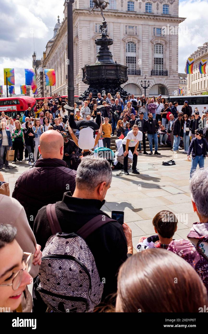Piccadilly Circus and the famous Eros statue with crowds of tourists in London , England , UK ...