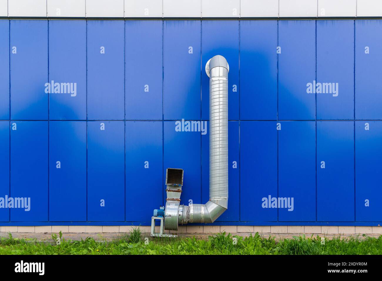 industrial grade air extraction duct with electrical motor on blue wall ...