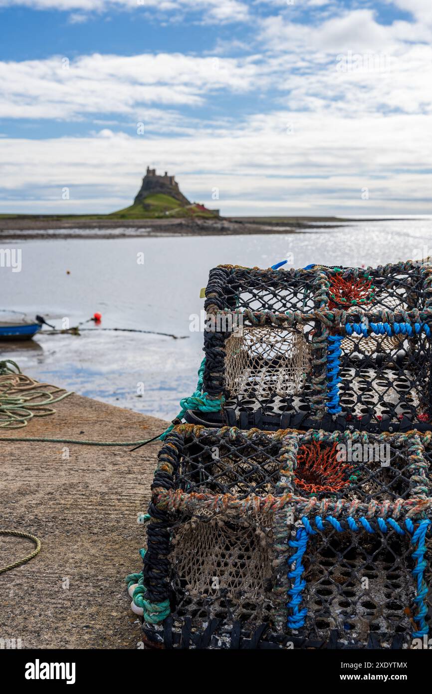 Lindisfarne Castle as viewed from the pier as a background to small ...