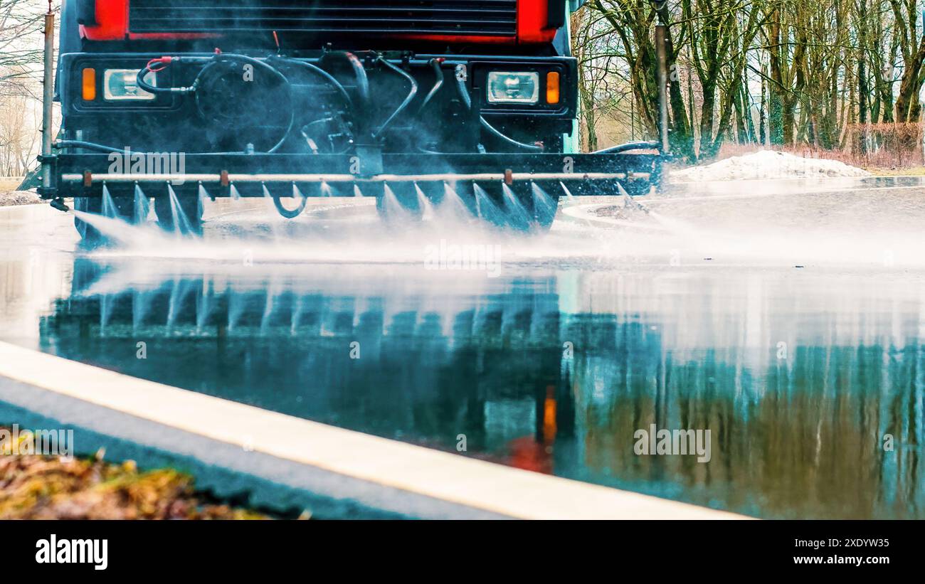 Cleaning sweeper machine washes the asphalt road with water spray Stock ...