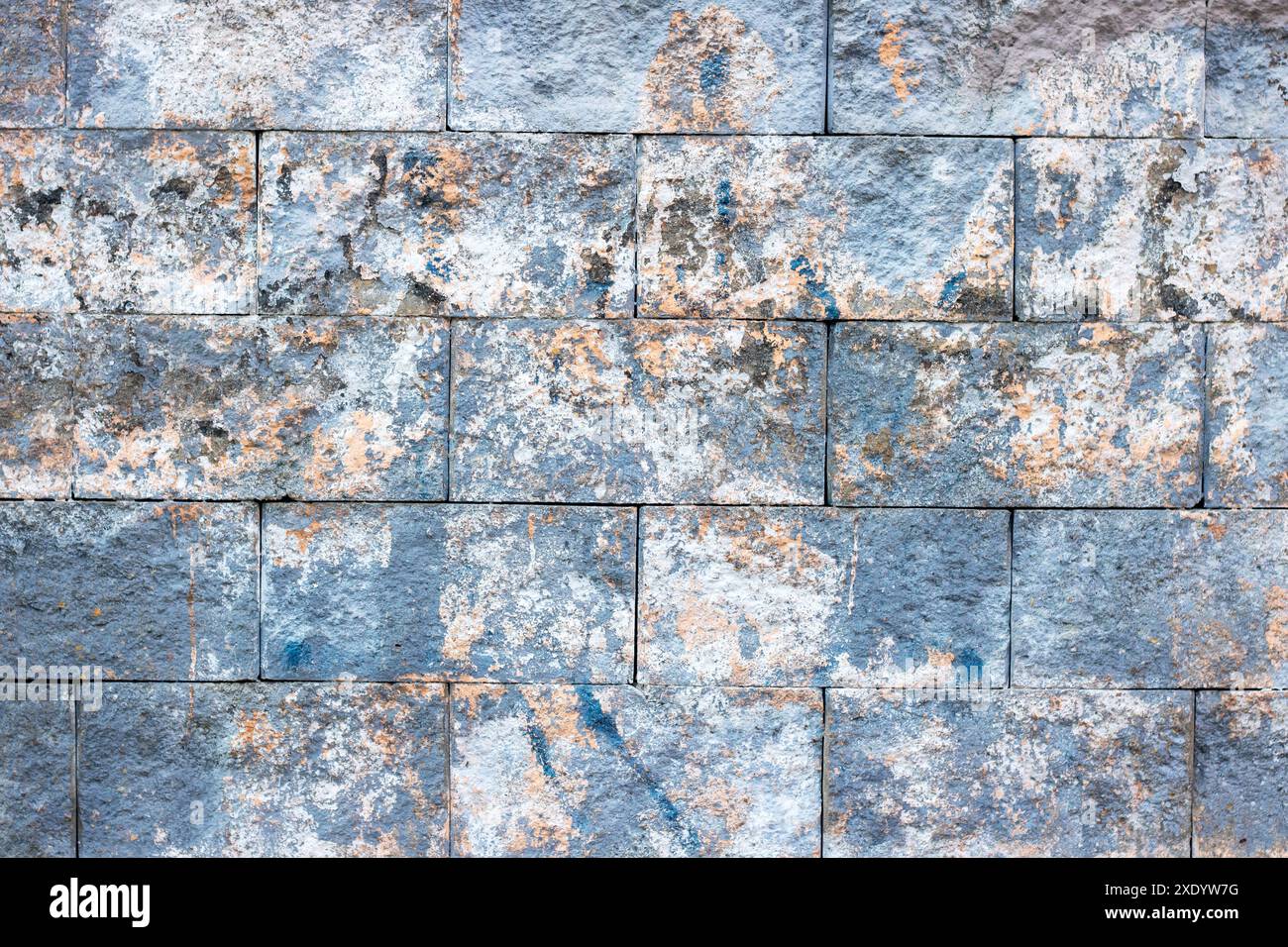 A closeup perspective of a brick wall with various stains covering its ...