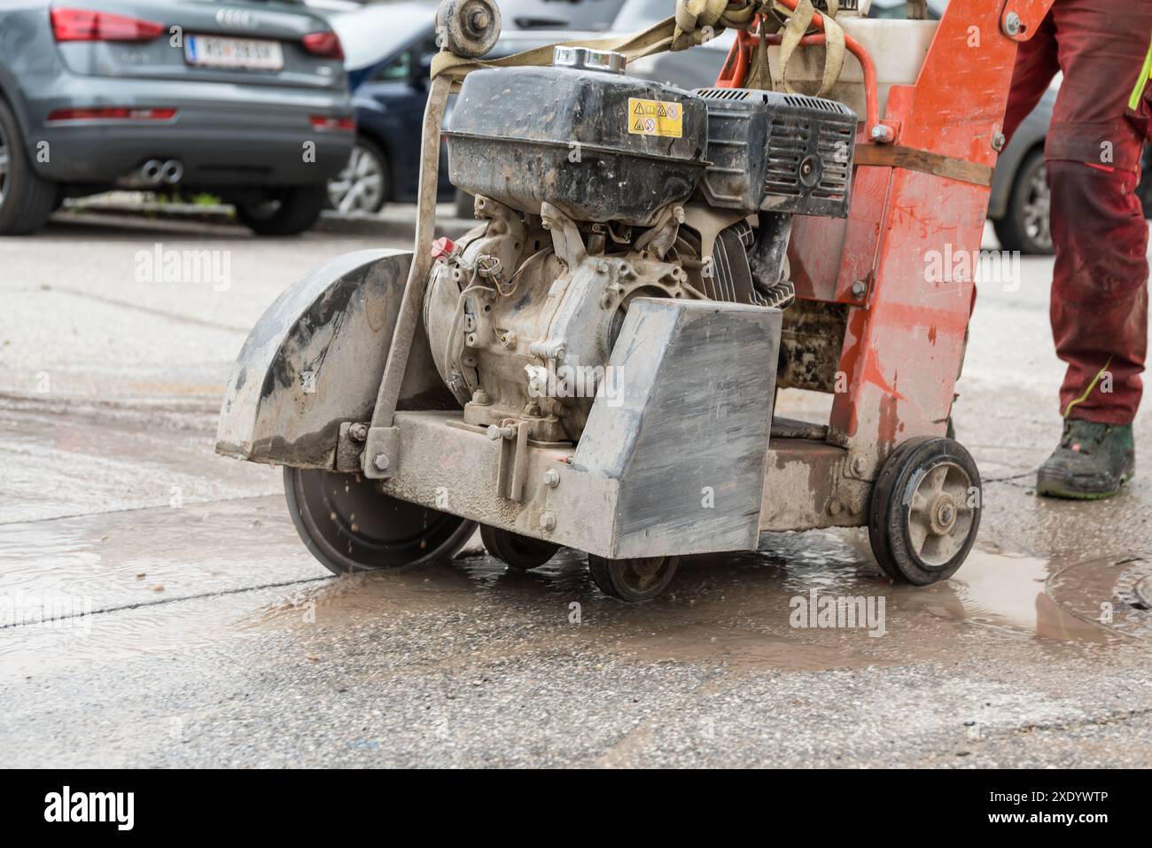 Construction worker cuts asphalt with joint cutter - Construction ...