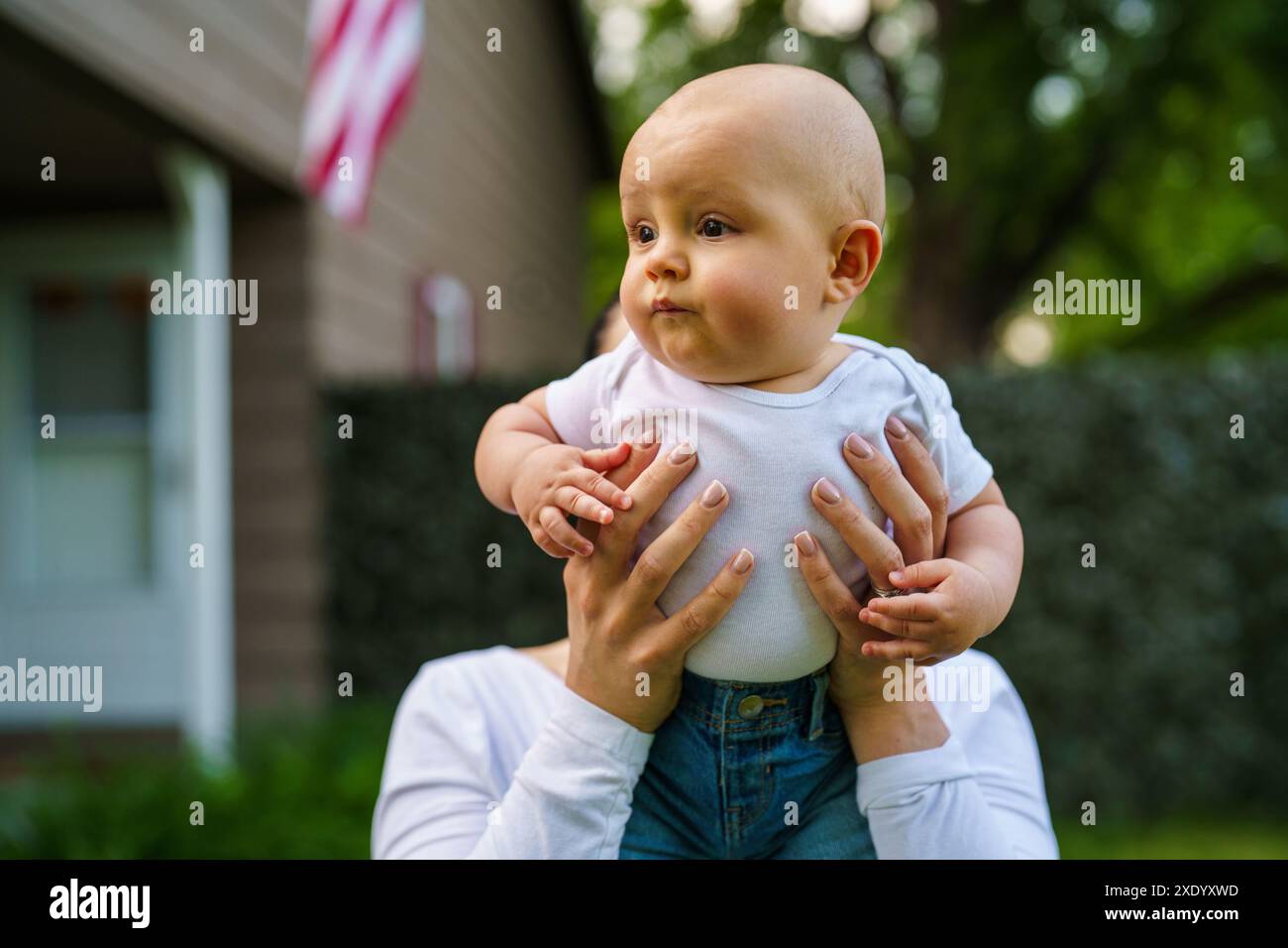 Family fly play with his son in front of the house playing enjoying ...