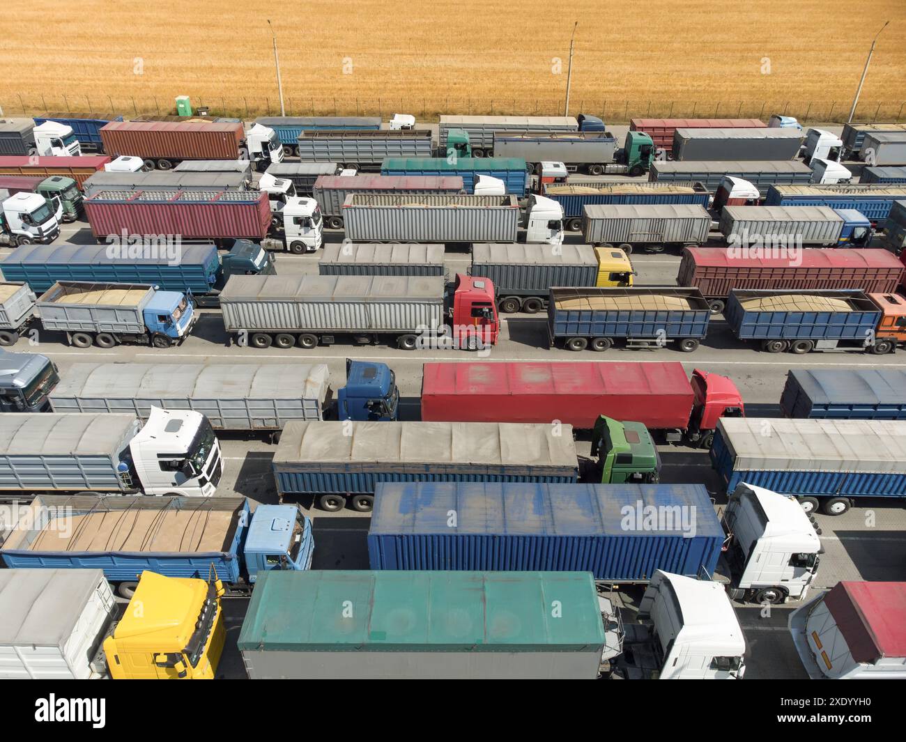 Trucks in line to unload grain at the port. Aerial view of many trucks ...