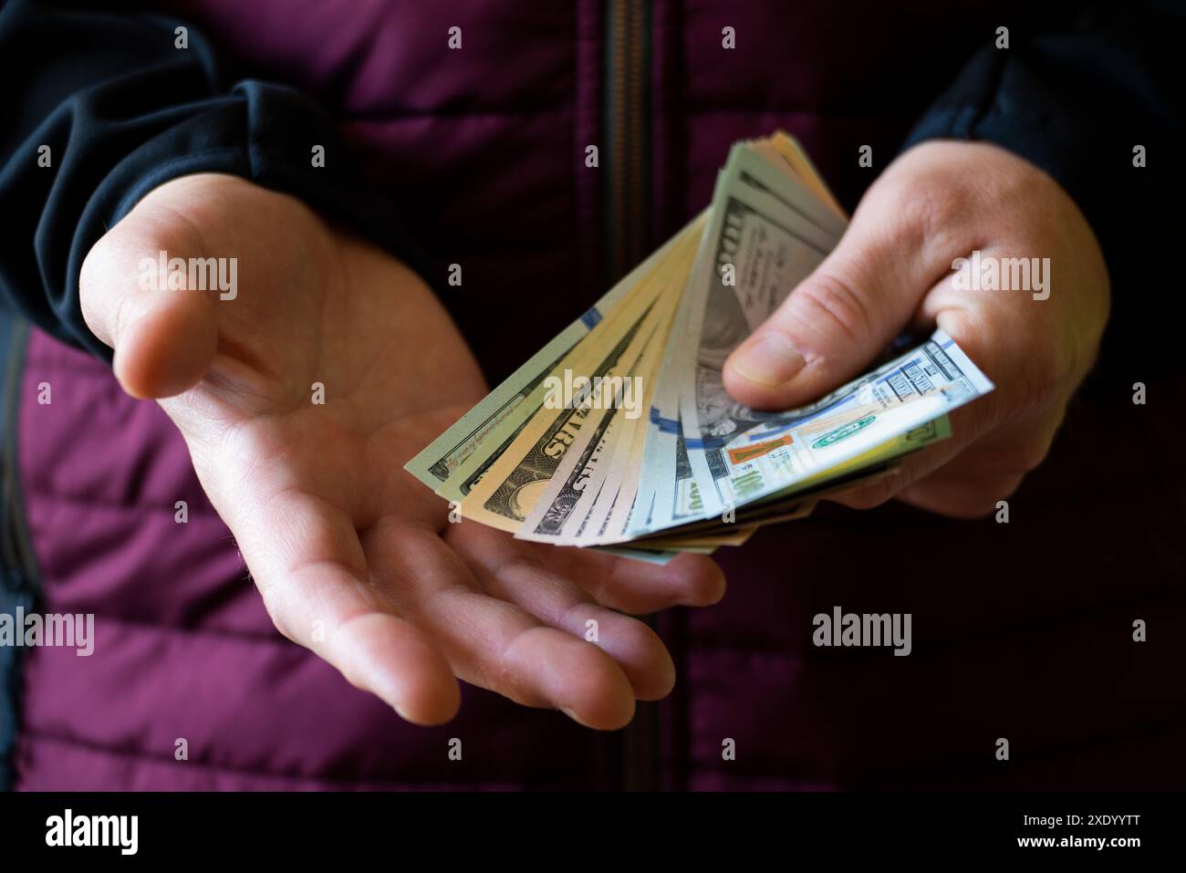 Male hands holding us dollar hi-res stock photography and images - Alamy