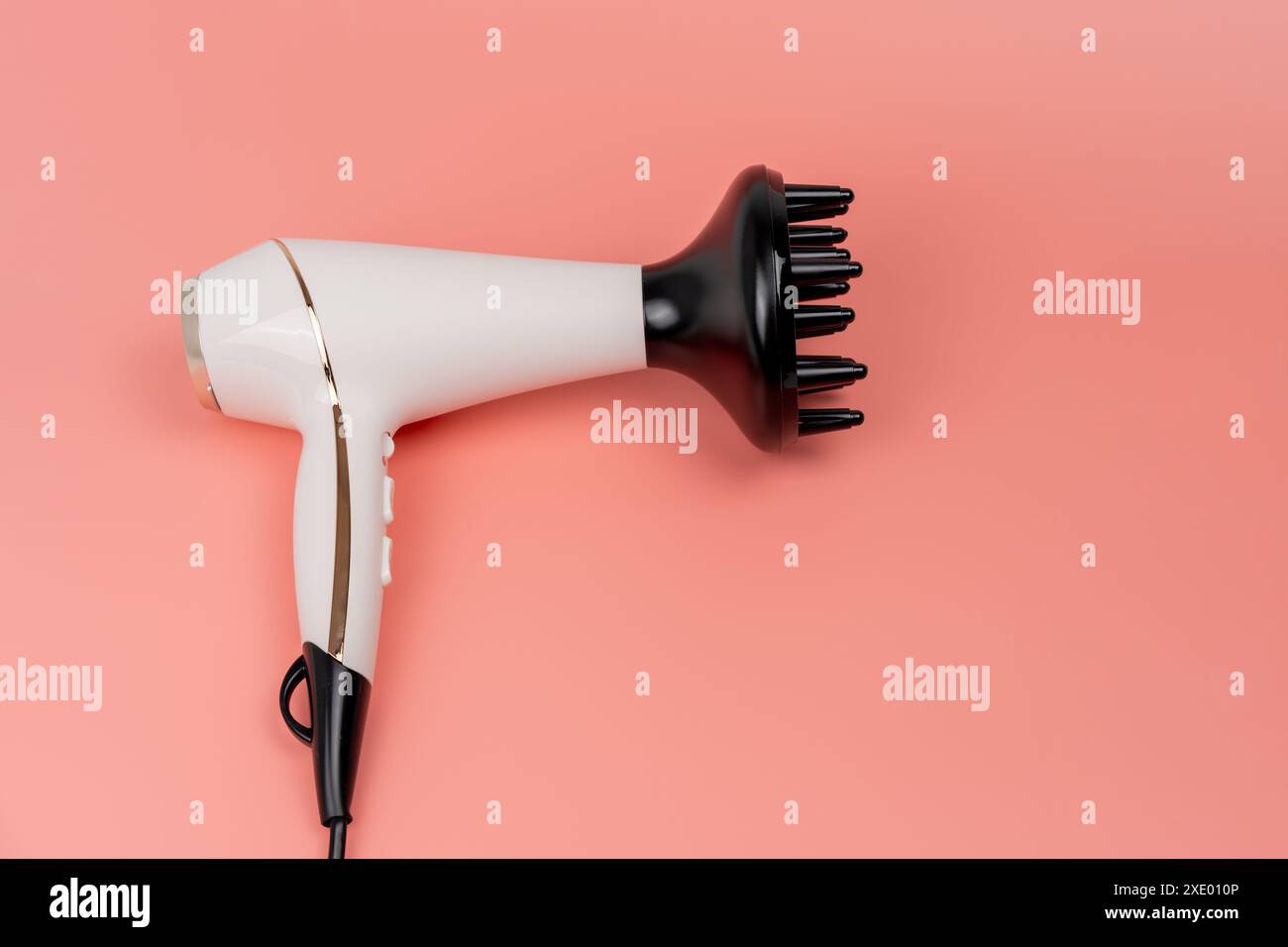 Hair dryer for drying hair on a pink background. The buttons are ...