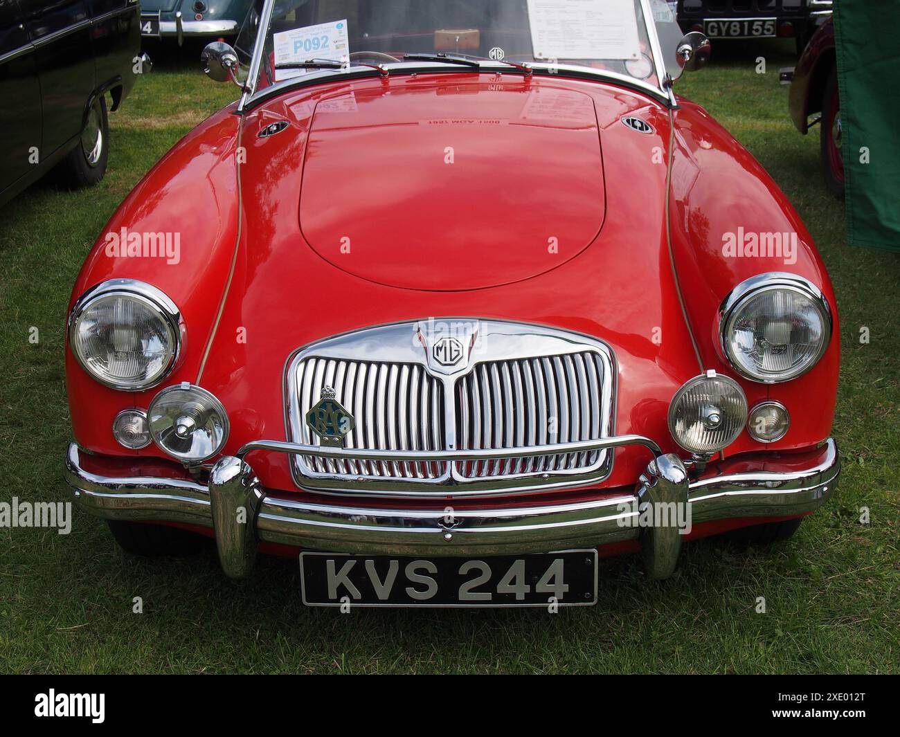 Front view of the headlights and bumper of a red mga sports car at the ...