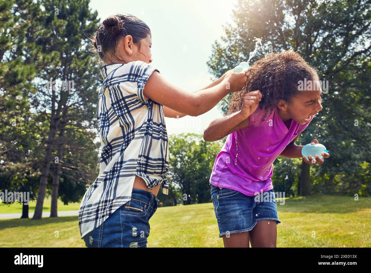 Water balloons, happy and girl kids in park with freedom, fun and ...
