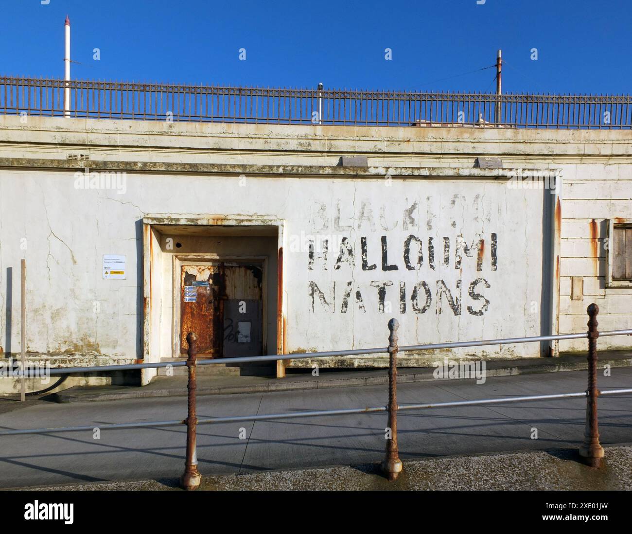 Faded peeling sign reading blackpool halloumi nations on an abandoned ...