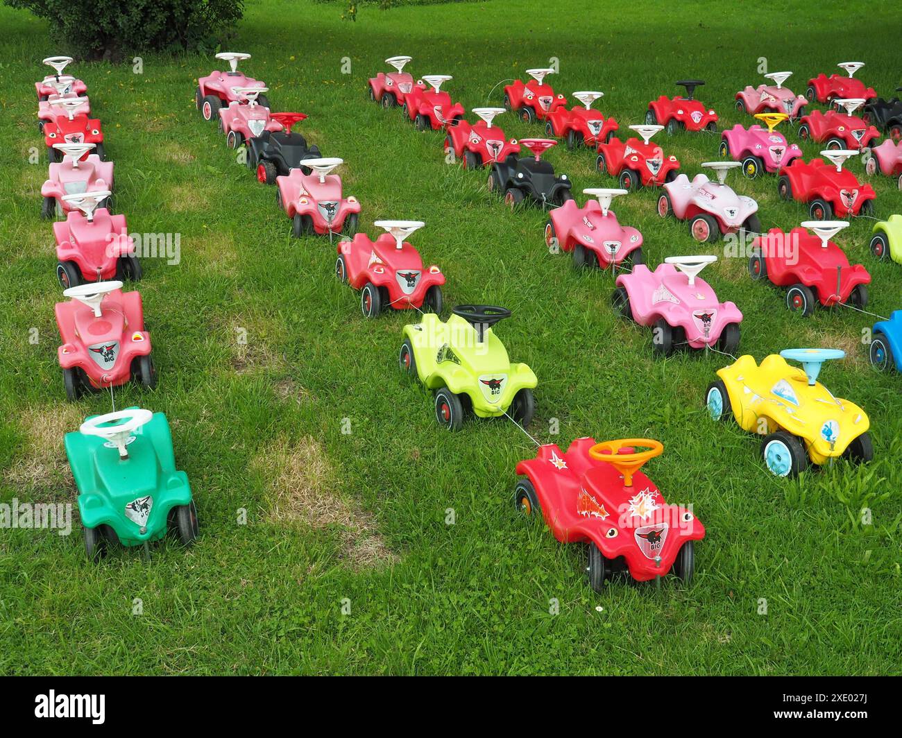 Children's push cars in rows Stock Photo - Alamy
