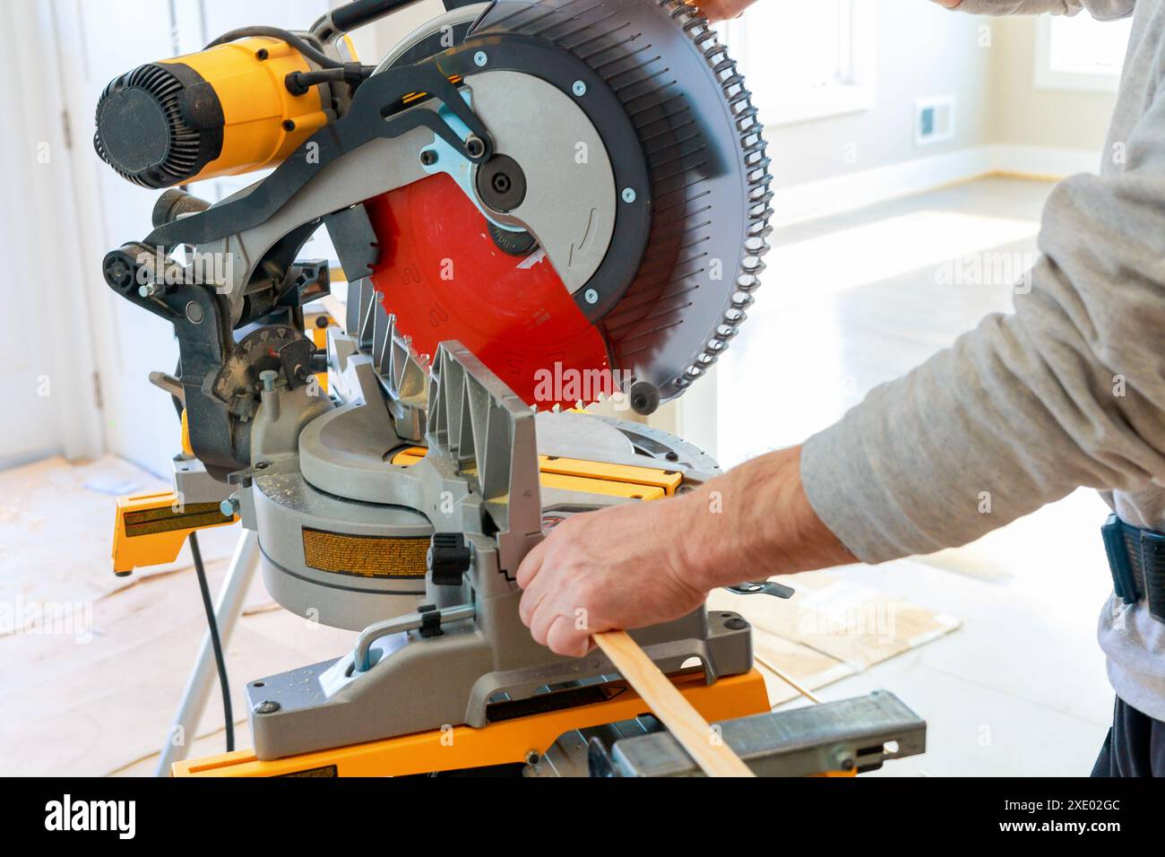 Contractor using circular saw cuts wooden moldings before installing ...