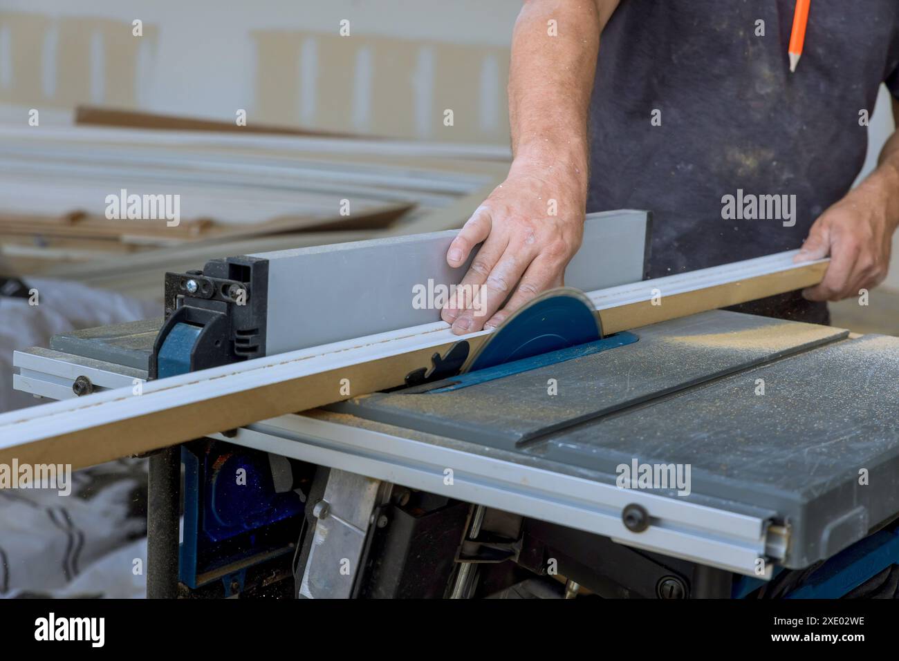 Table saw powered by electricity is used to cut wood molding filler ...
