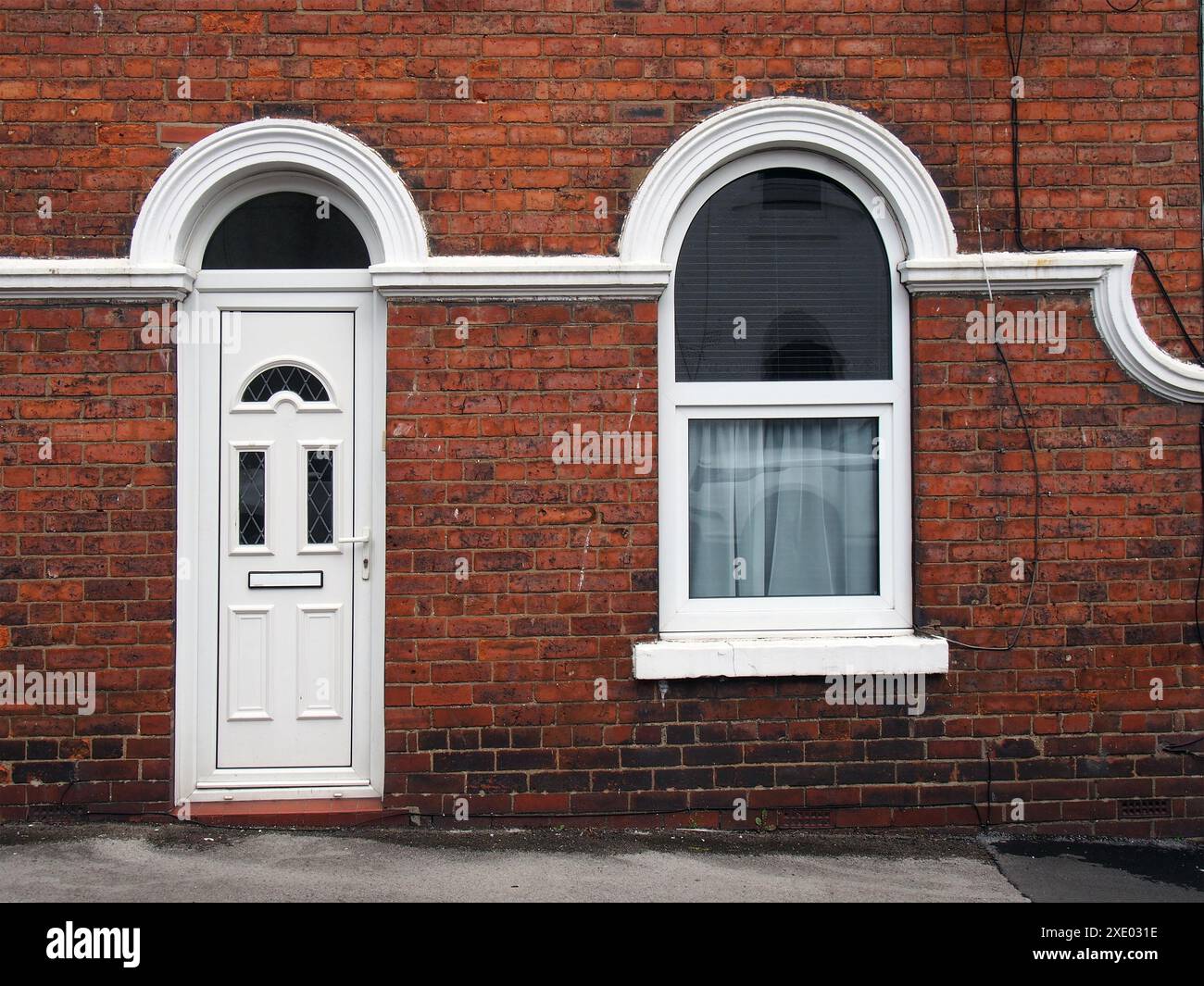 White front door and window of a typical old brick british terraced ...