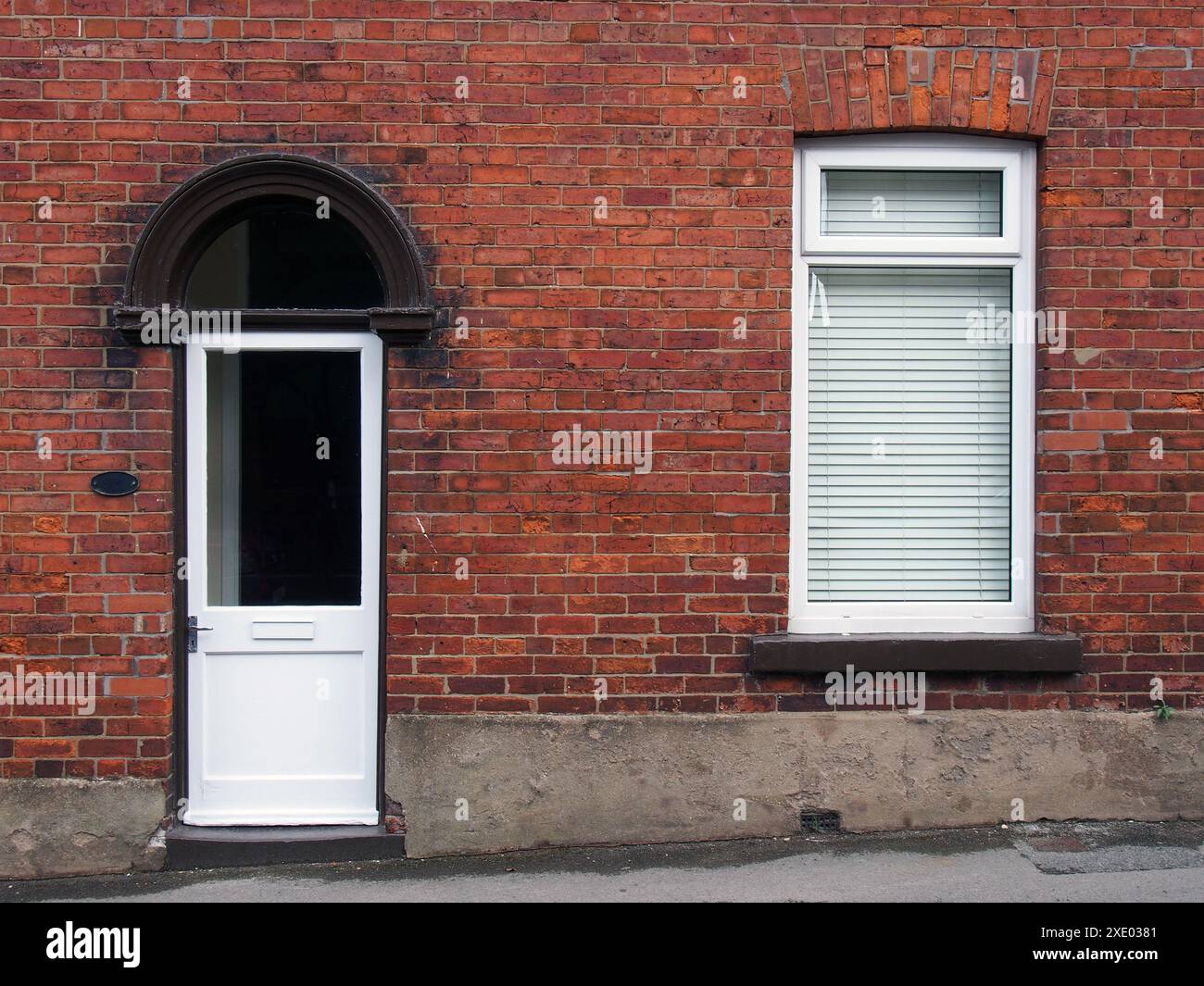 White front door and window of a typical old brick british terraced ...