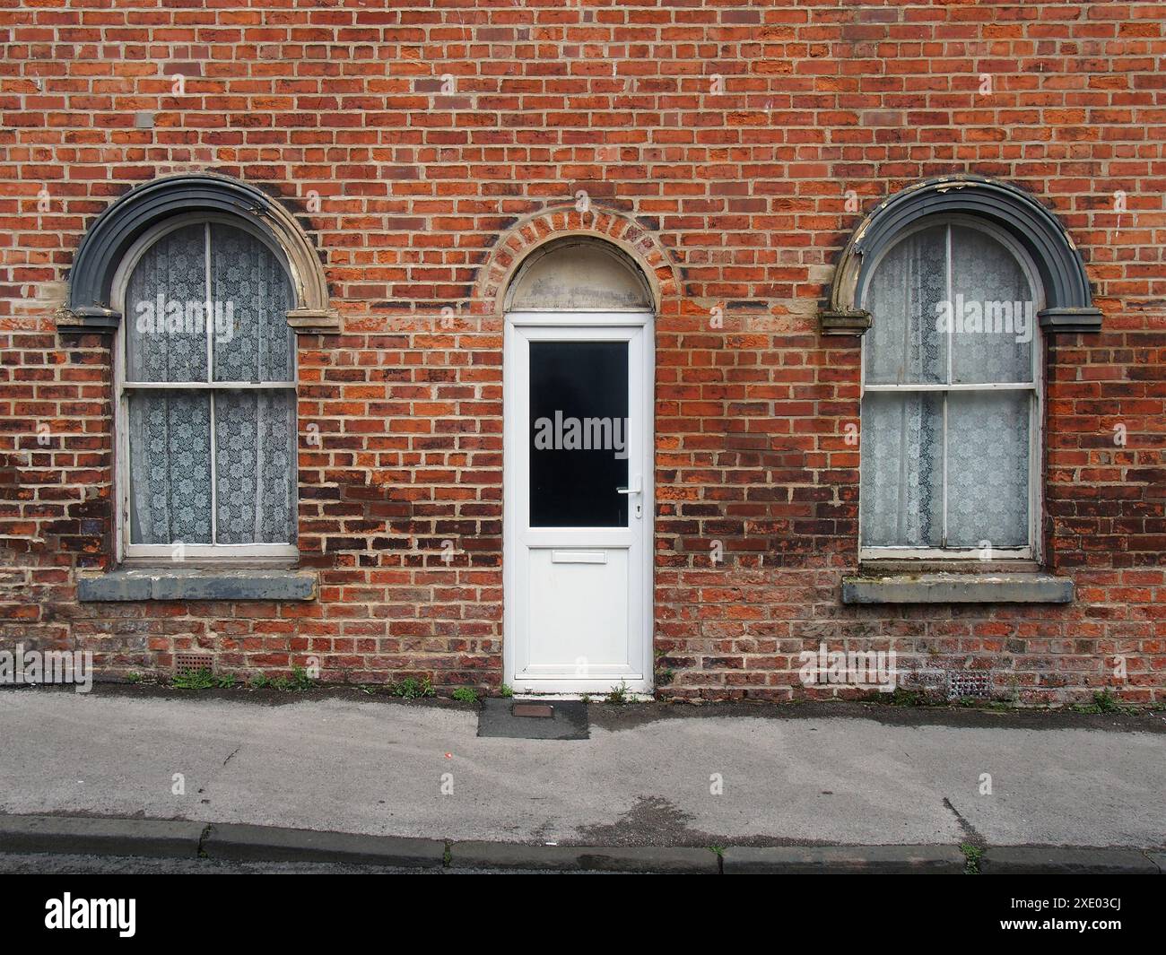White front door and windows of a typical old brick british terraced ...