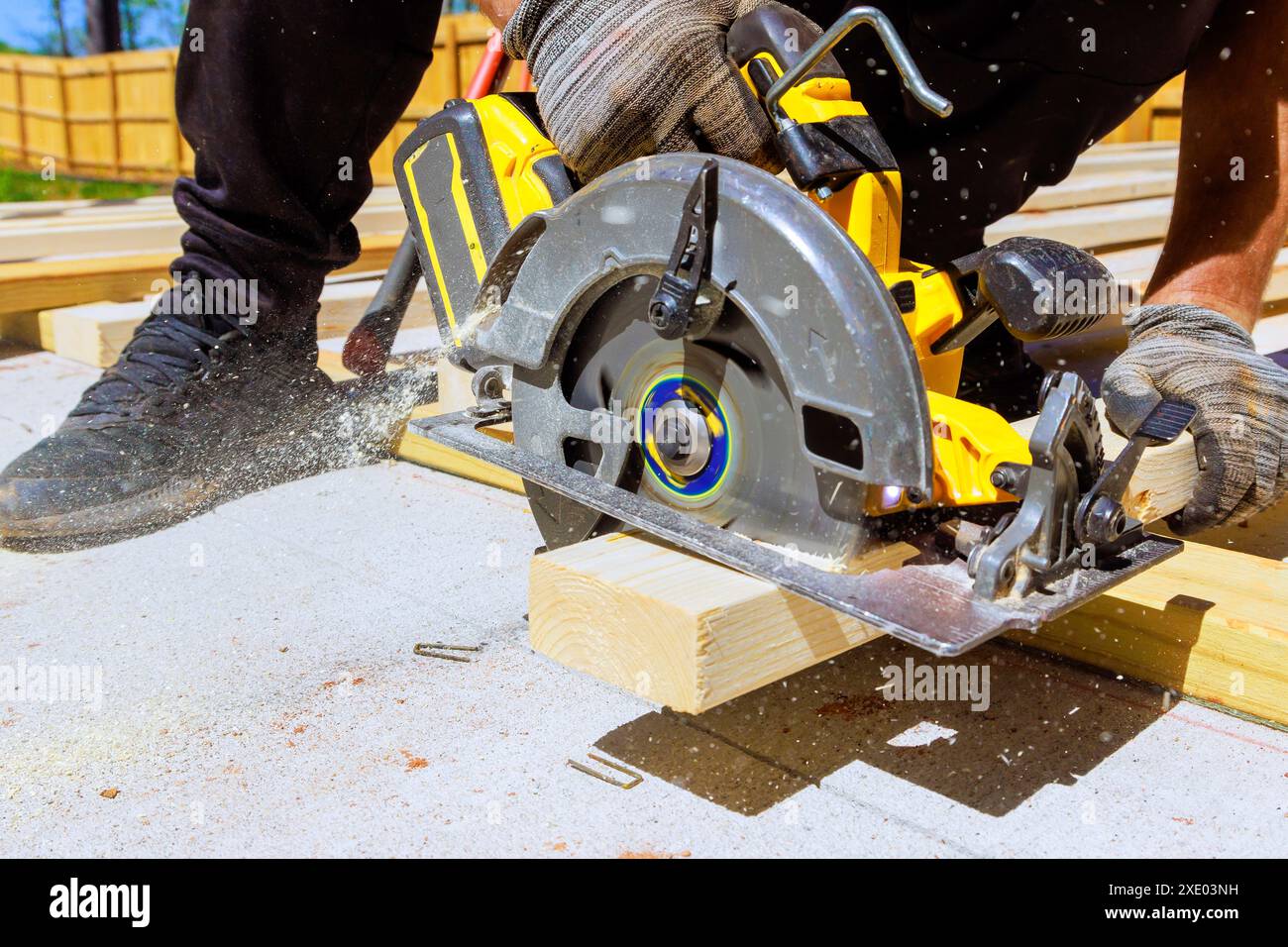 Wood beams are cut using an electrically powered circular saw Stock ...