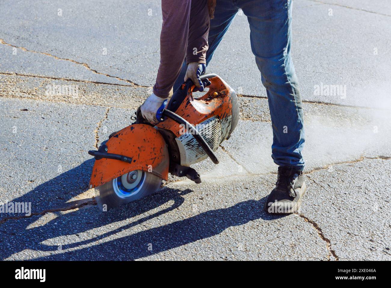 An asphalt in parking lot is cut using diamond blade saw machine by ...