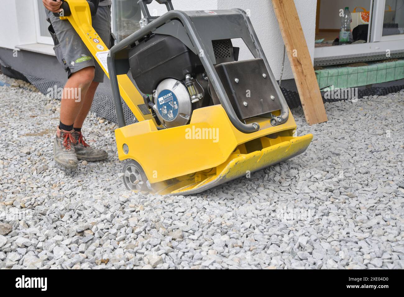 Workers in the construction industry works with vibration plate on ...