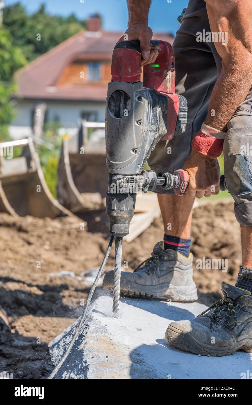 Craftsman on a construction site with a hammer drill - construction ...