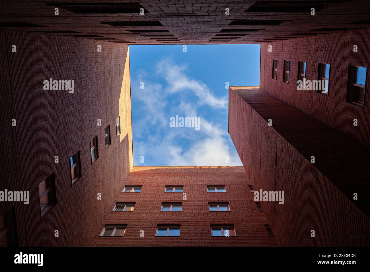 Brick high-rise new square house on a blue sky background Stock Photo ...