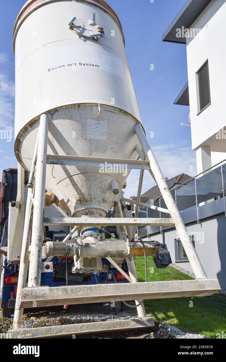 Construction company sets up a concrete silo on the construction site ...