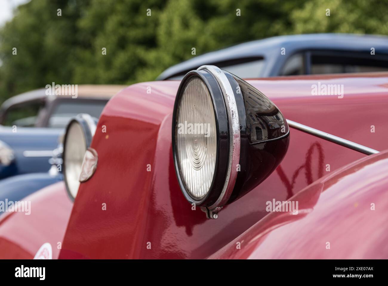 Luxury red car and valuable vintage car - closeup Stock Photo - Alamy
