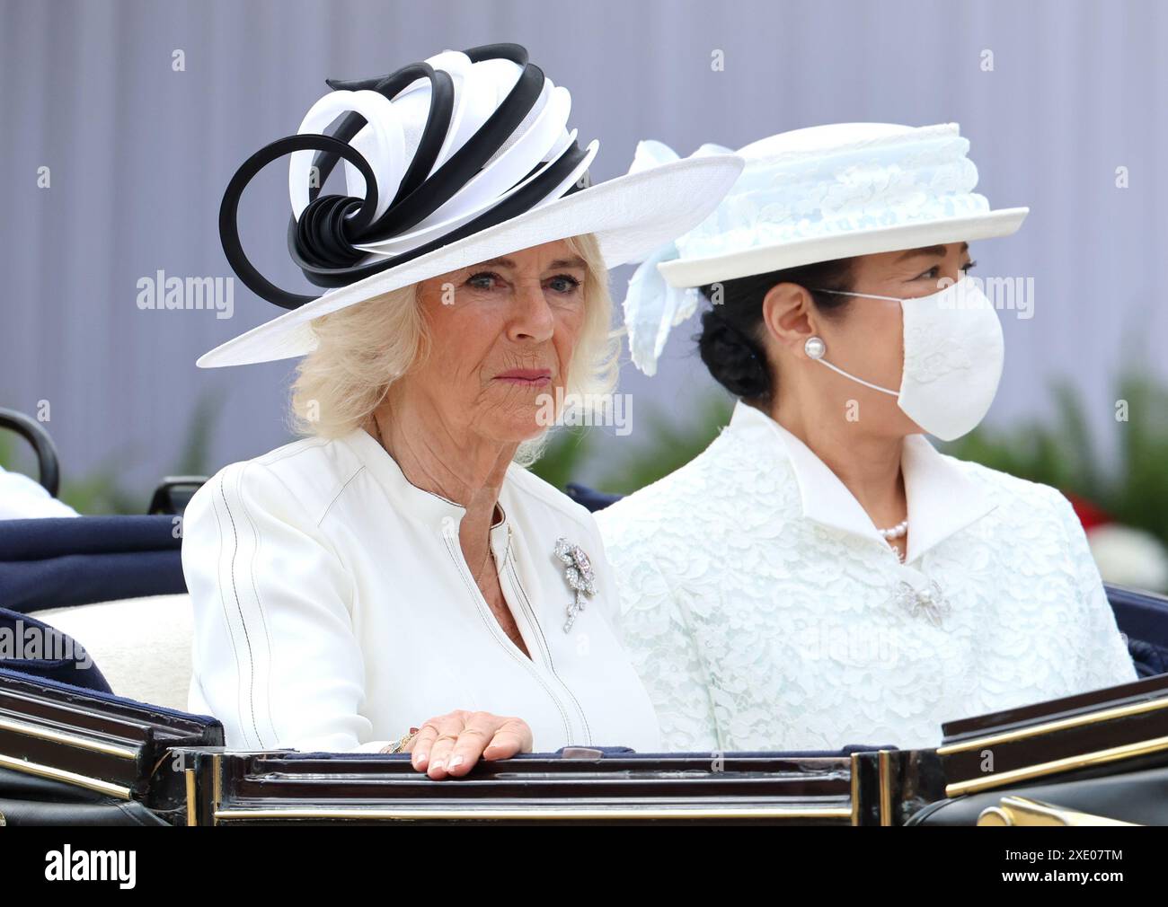 Queen Camilla and Empress Masako of Japan travel in a carriage ...