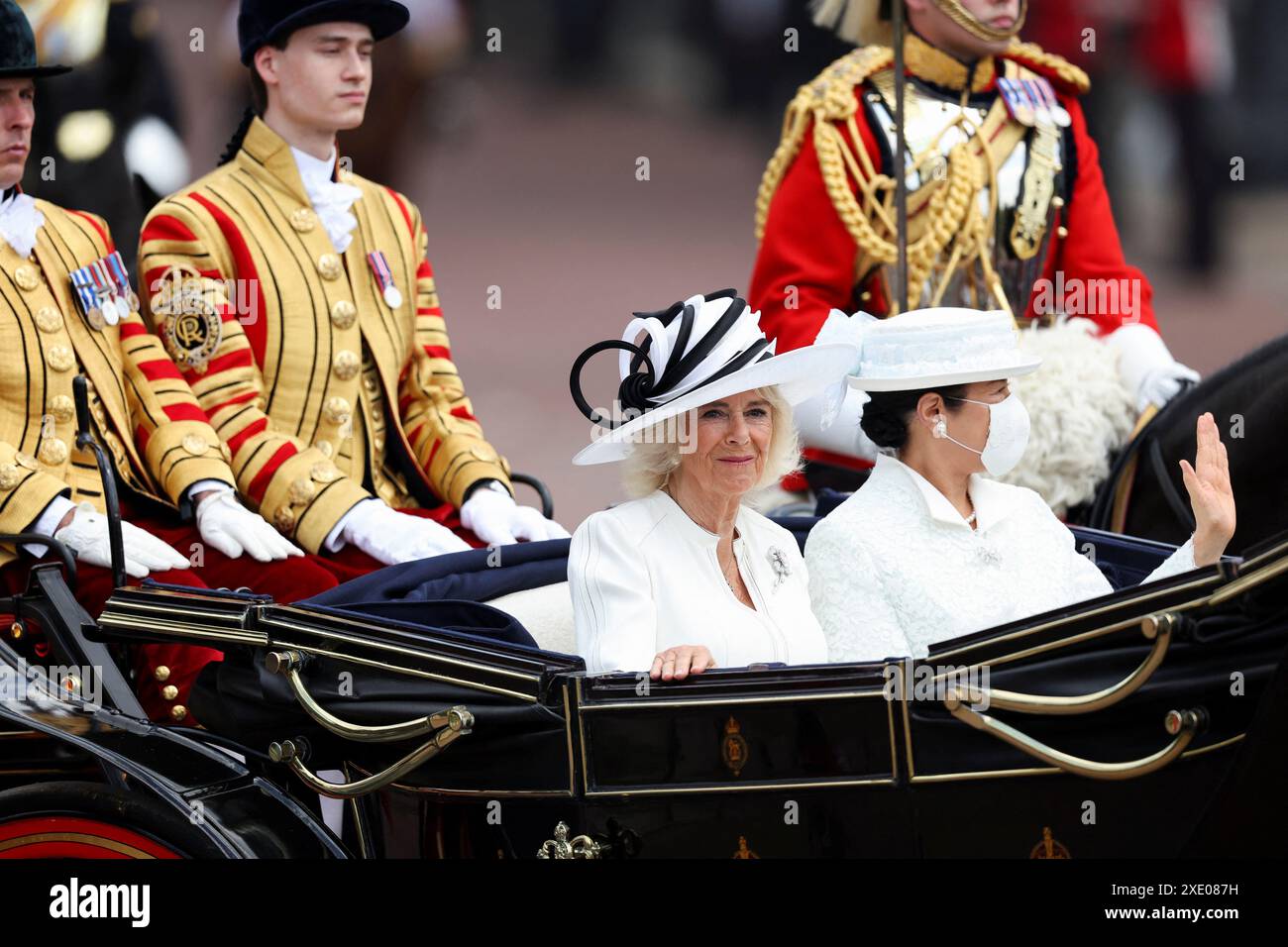 Queen Camilla (left) and Empress Masako of Japan make their way along ...