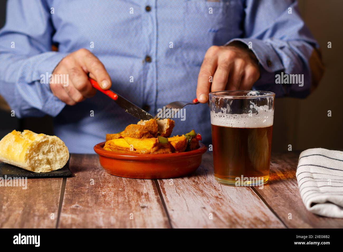 Man eating meatballs with spaghetti and beer Stock Photo - Alamy
