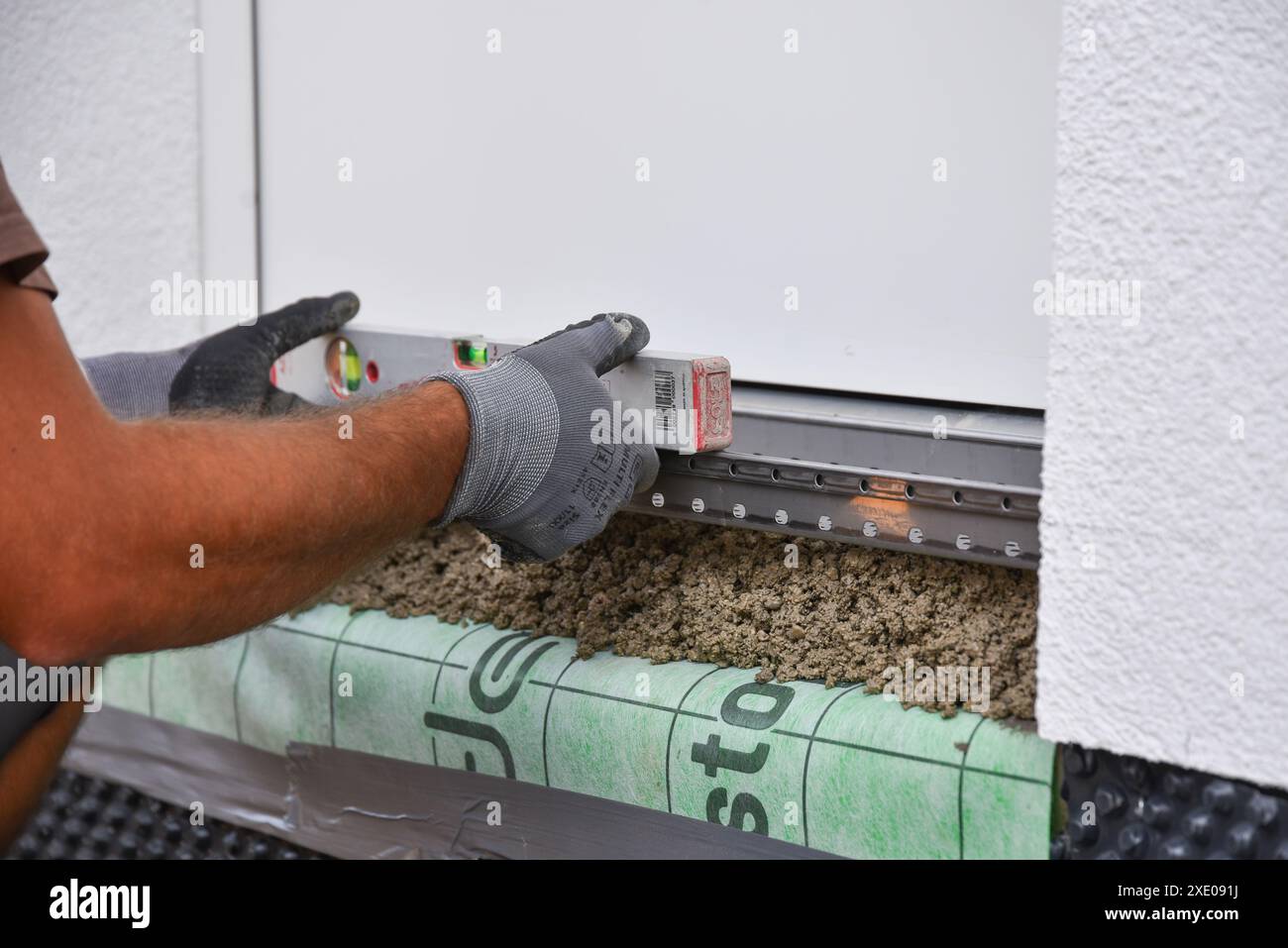 Craftsman with spirit level at the construction site - construction ...