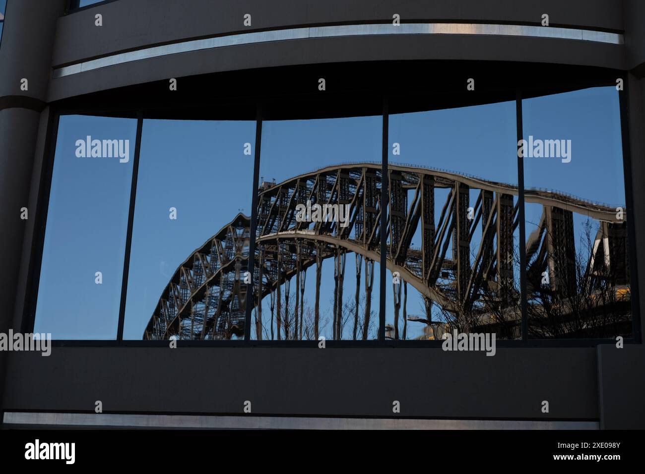 Panorama of the sydney harbour bridge in window panels, reflected and ...